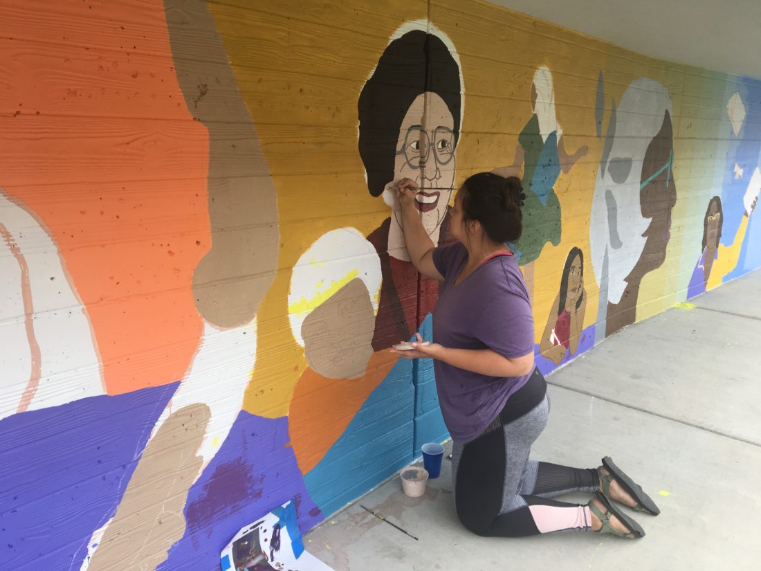 Painting underway on women of color mural at Lawrence Public Library ...